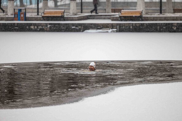 Break the ice: Winter swimming enthusiasts brave cold to swim in partly ...