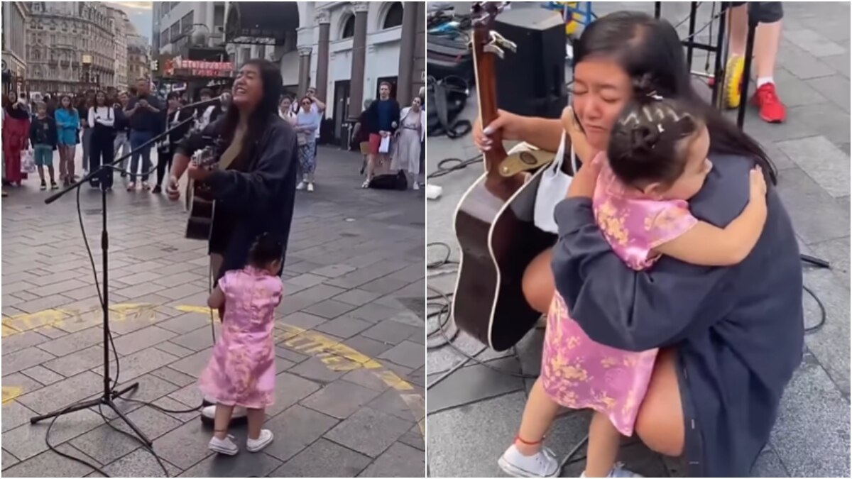 Little girl runs and hugs street singer during performance ...