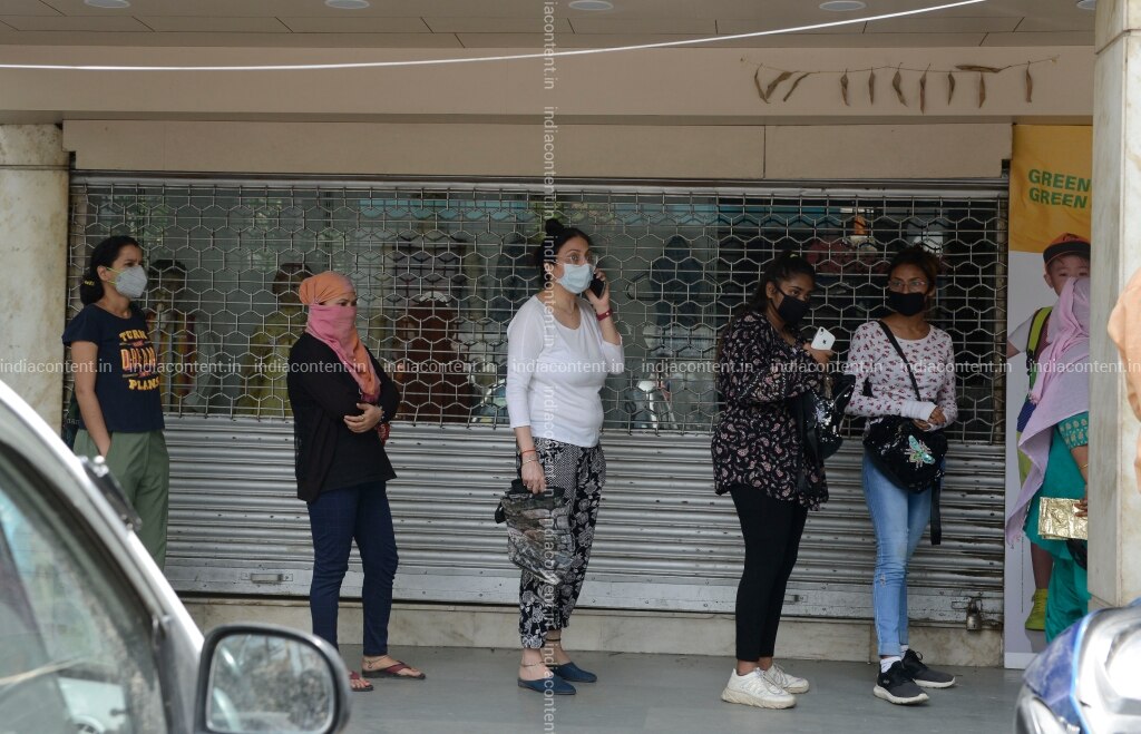 Buy People stand in queue at a wine shop during government imposed ...